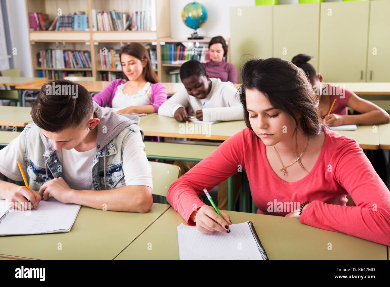 Smiling multiethnic students studying together in the classroom Stock ...