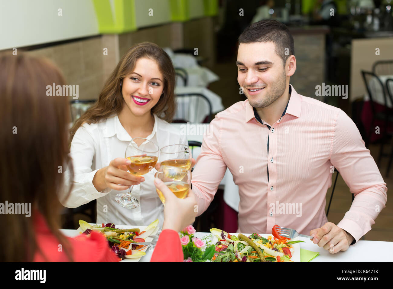 Happy smiling friends celebrates holiday in restaurant. Focus on man ...