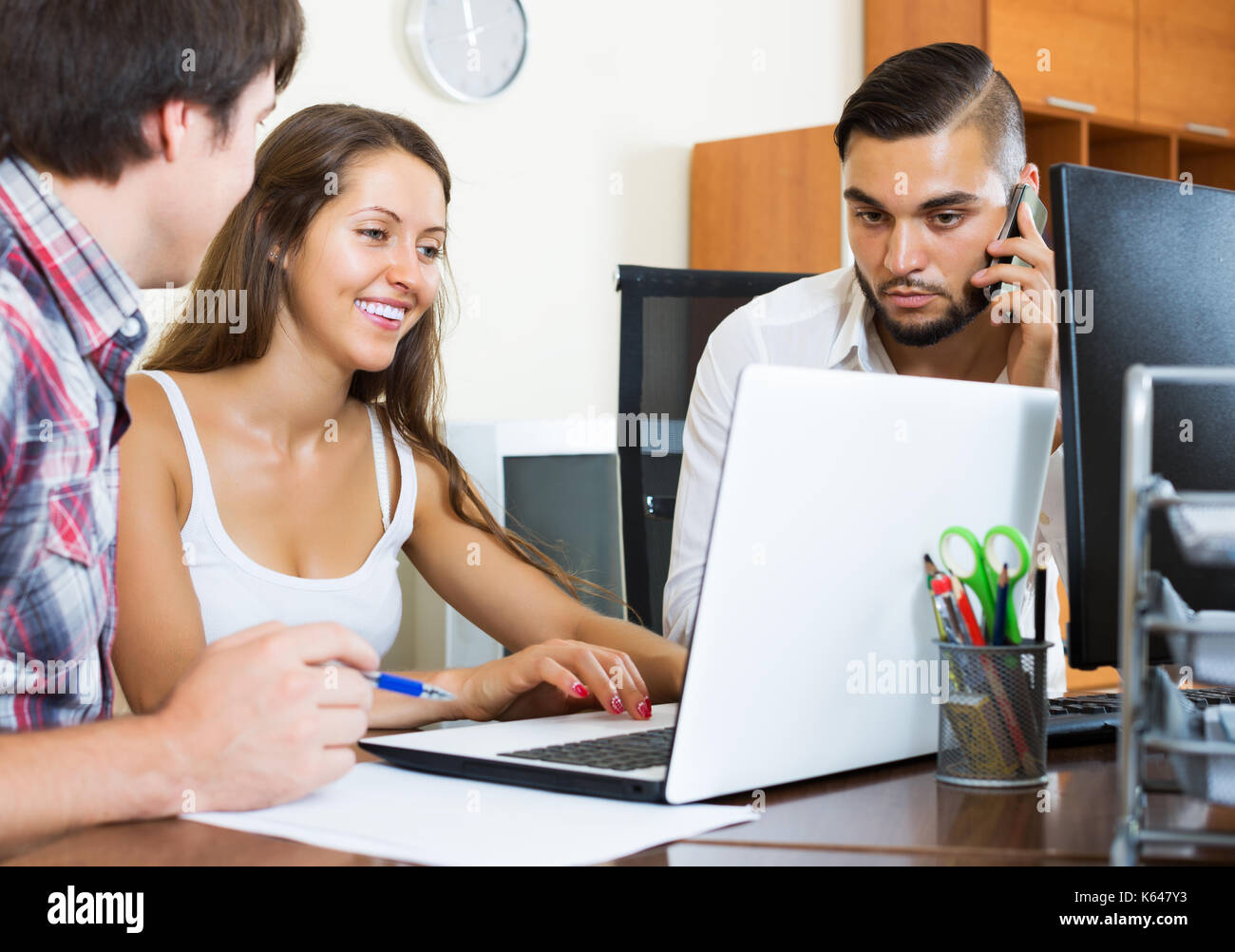 Group of adult people have fun while watching something on laptop Stock ...
