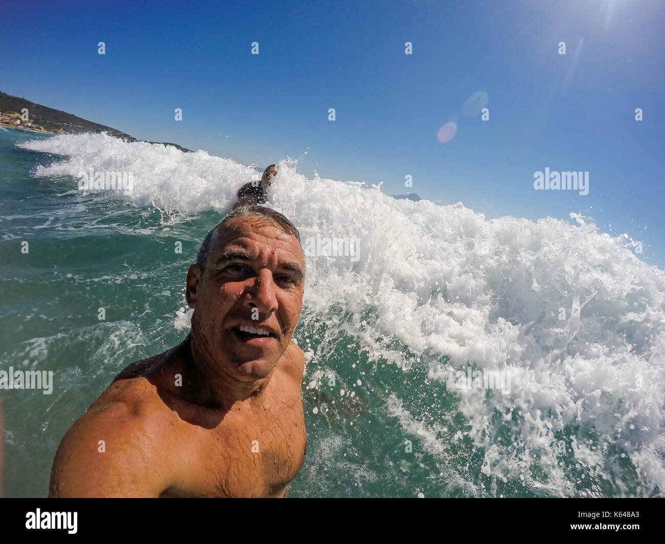 Couple splashing in the sea hi-res stock photography and images - Alamy