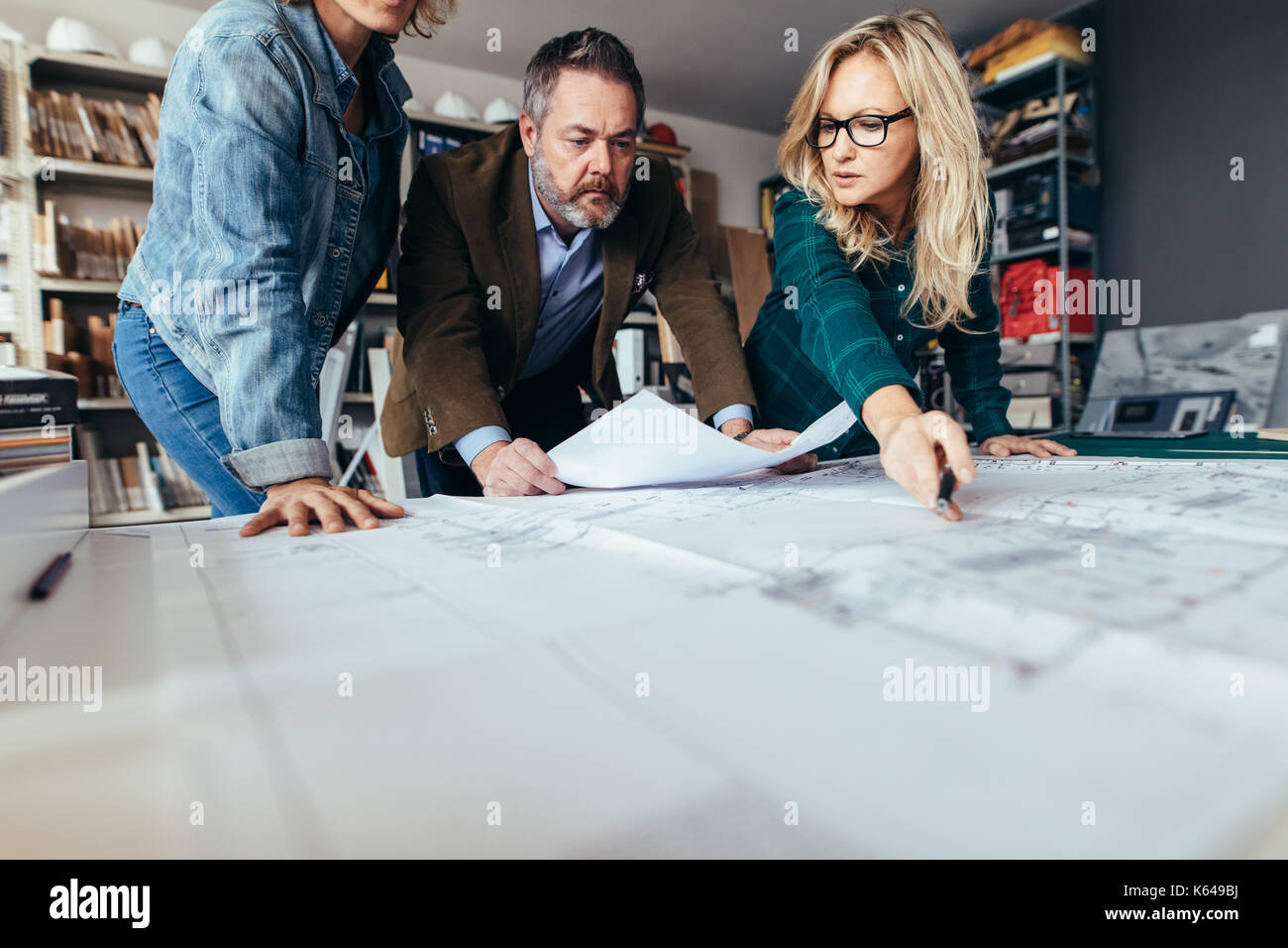 Team of architects working on construction drawing. business people ...