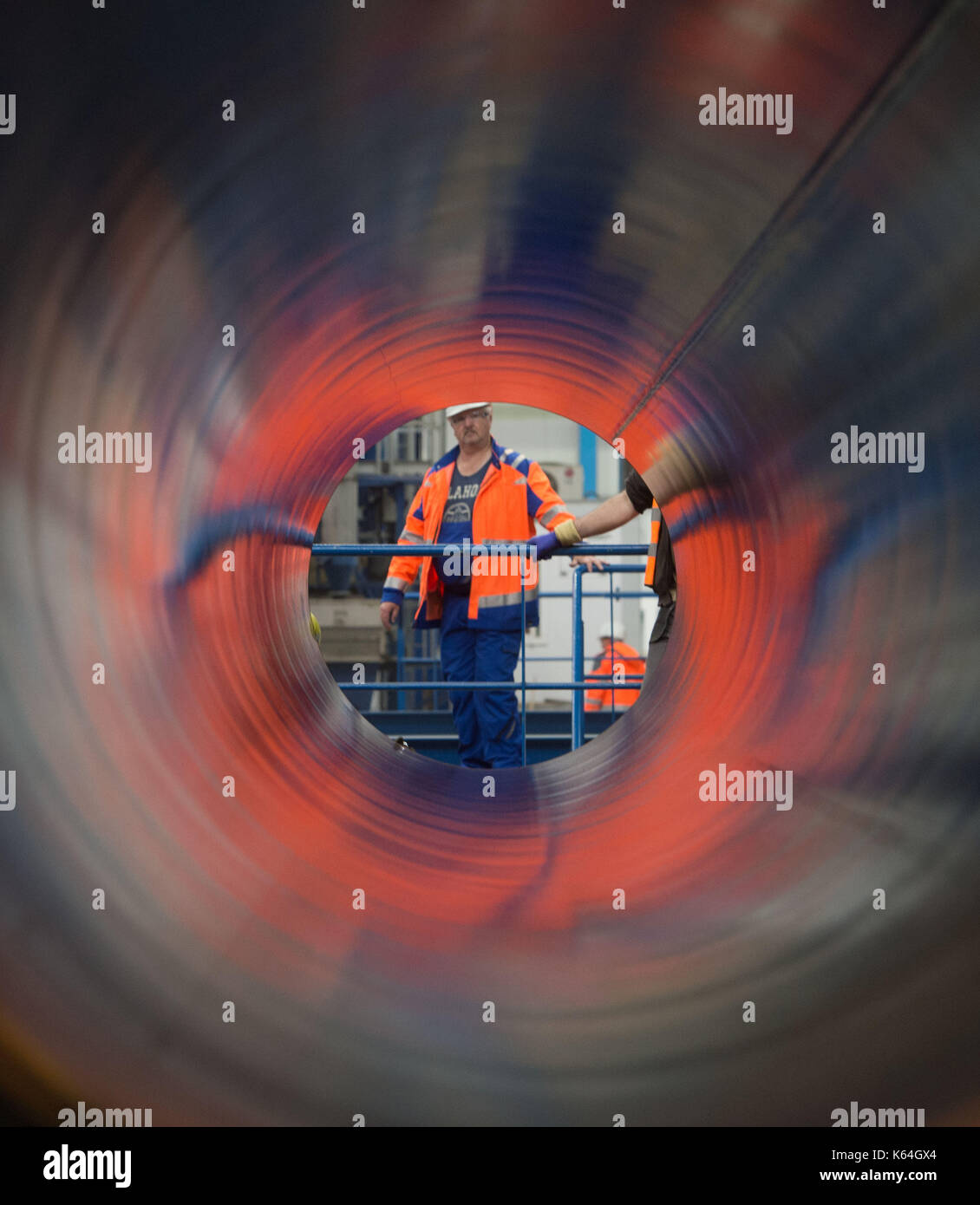 A steel pipe is being coated in concrete in the Wasco coating plant on ...