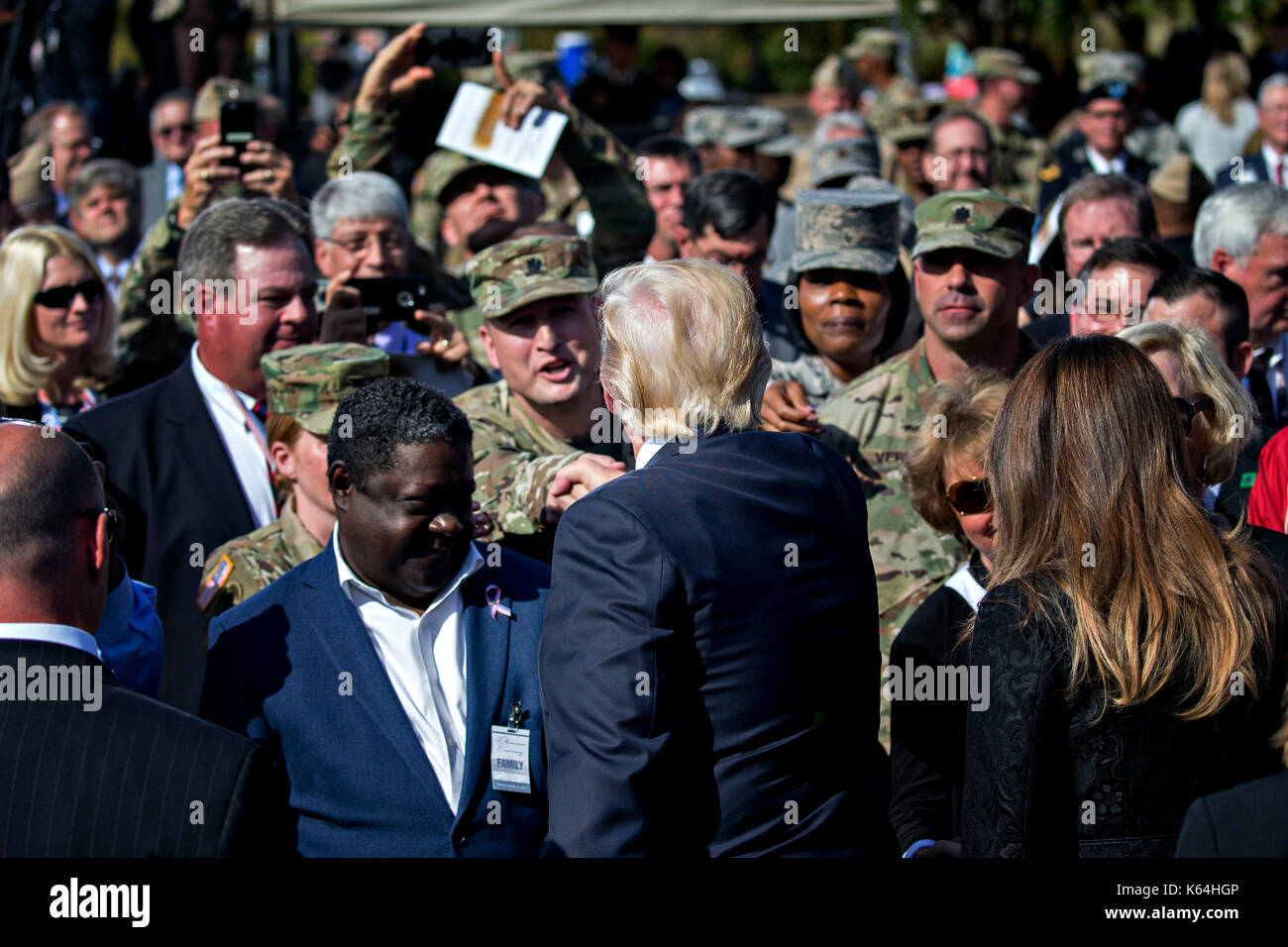 United States President Donald J. Trump, center, shakes hands with an ...