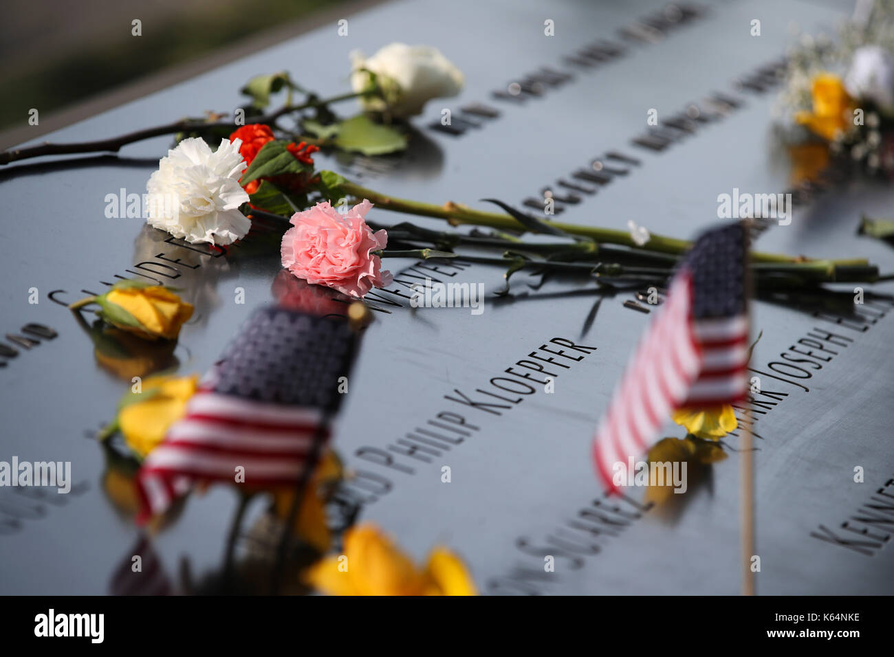 9 11 memorial with flowers and flags hi-res stock photography and ...