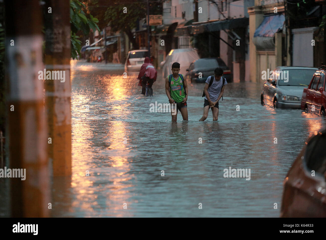 Makati City, Philippines. 12th Sep, 2017. Residents wade through flood ...