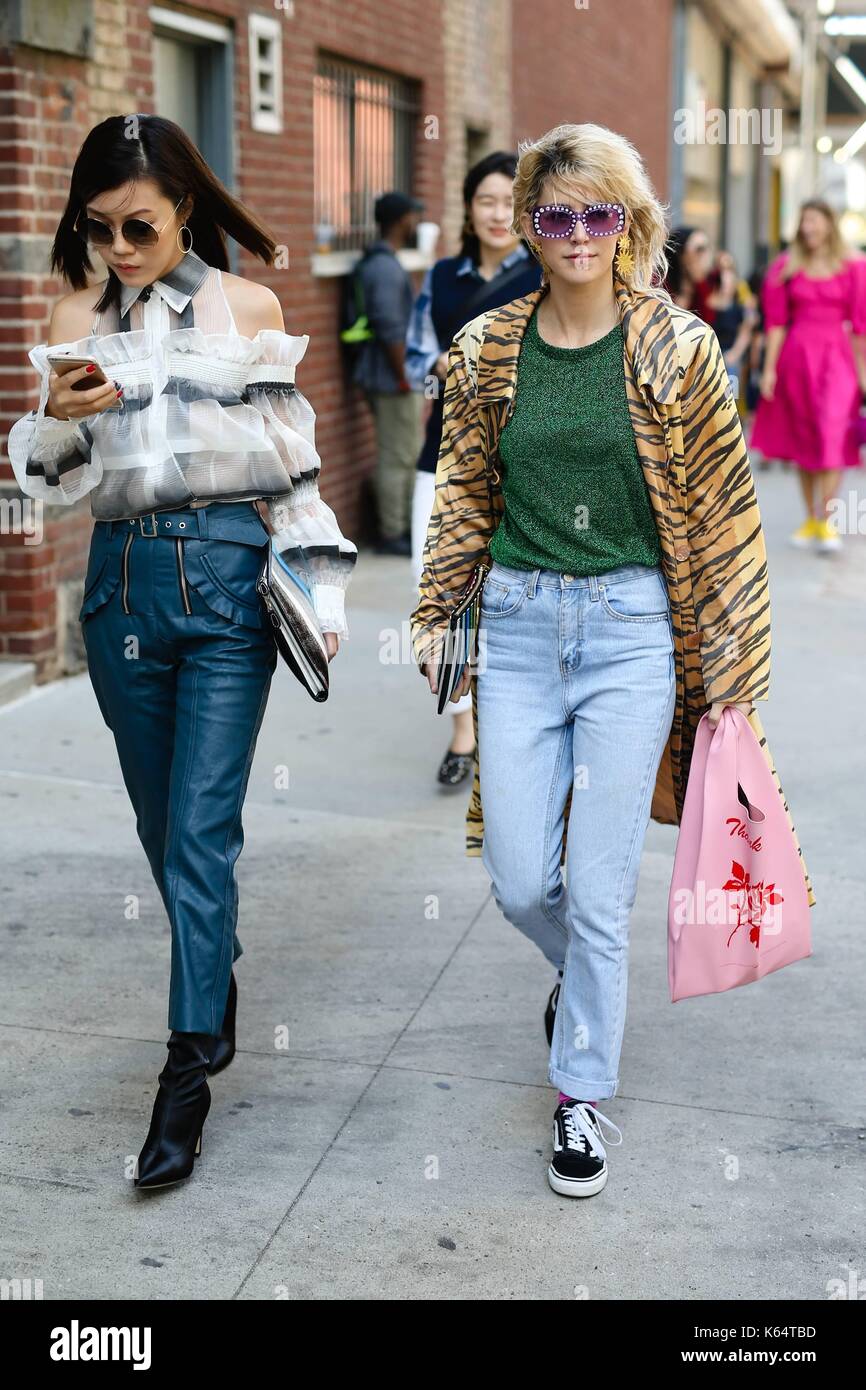 A chic showgoer walking outside of the Self Portrait runway show during ...