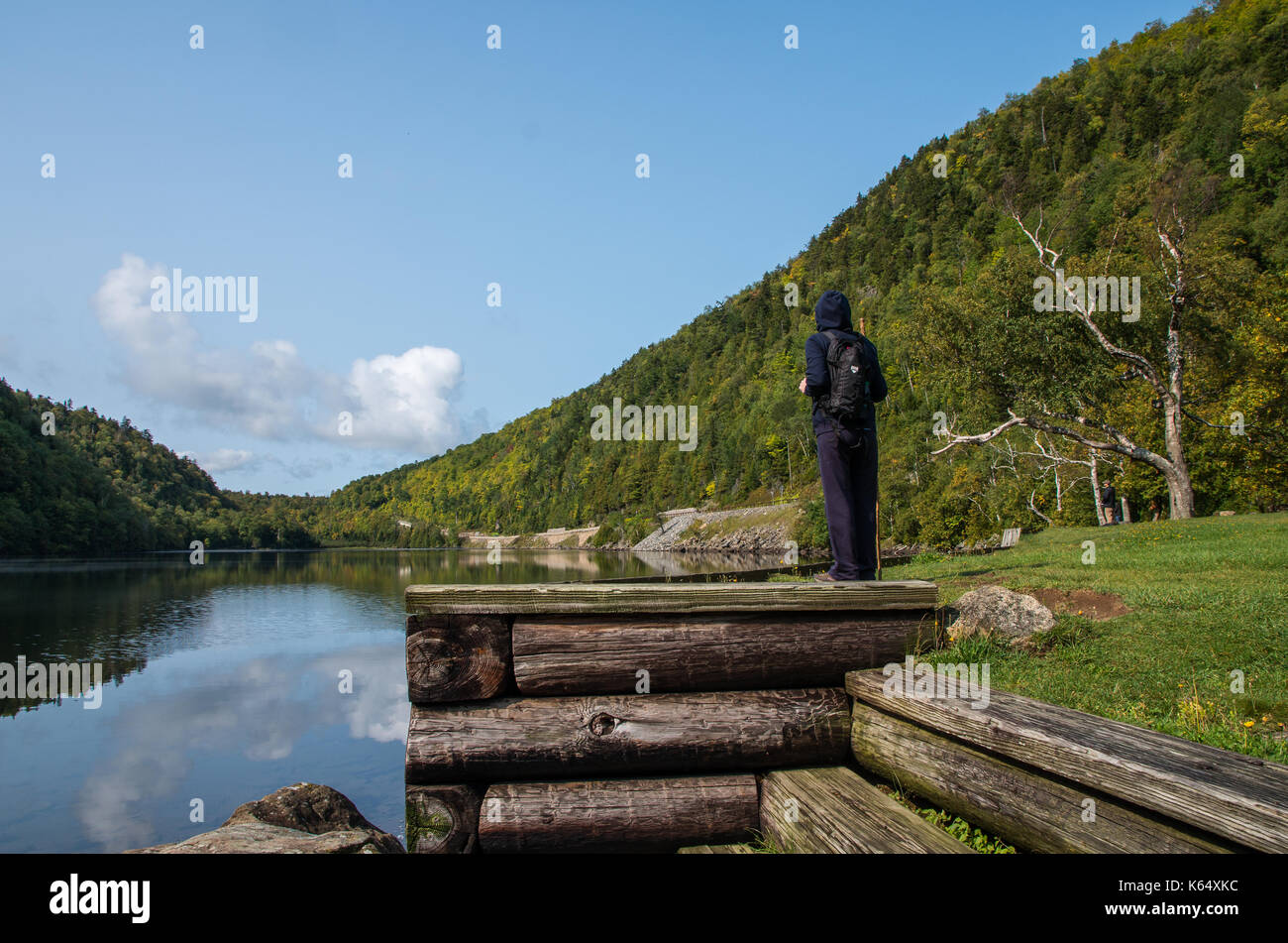 Hiker looking across the lower Cascade lake in Keene New York Stock ...