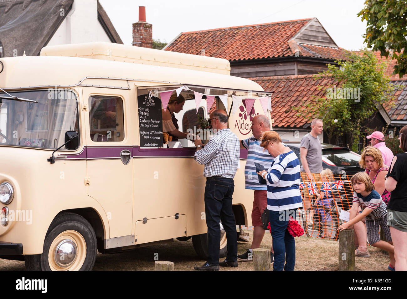 Customers buying ice cream at the village fete in Walberswick , Suffolk ...