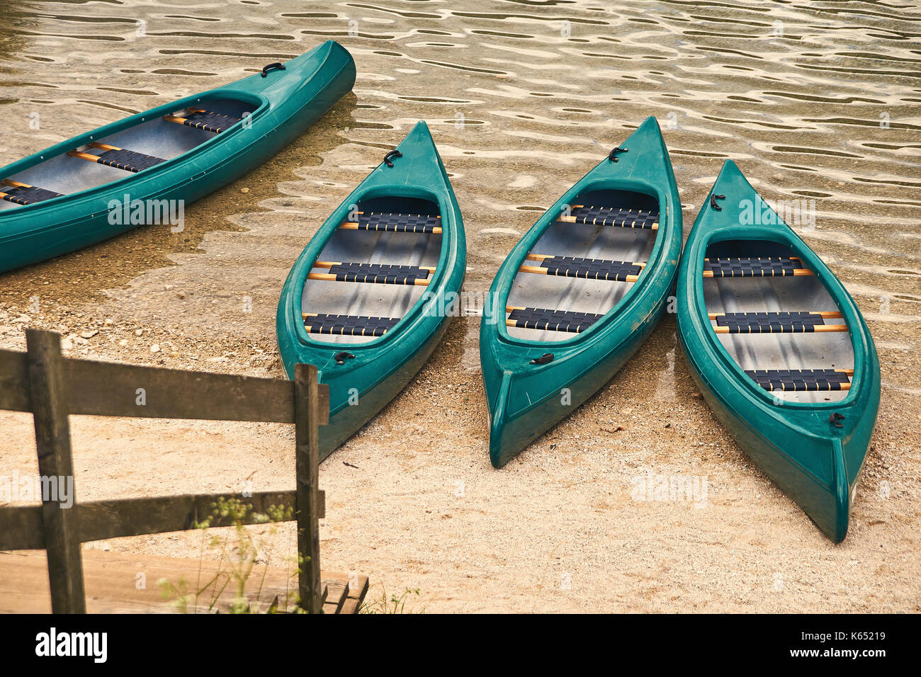 Green tourist boats on the lake beach Stock Photo - Alamy