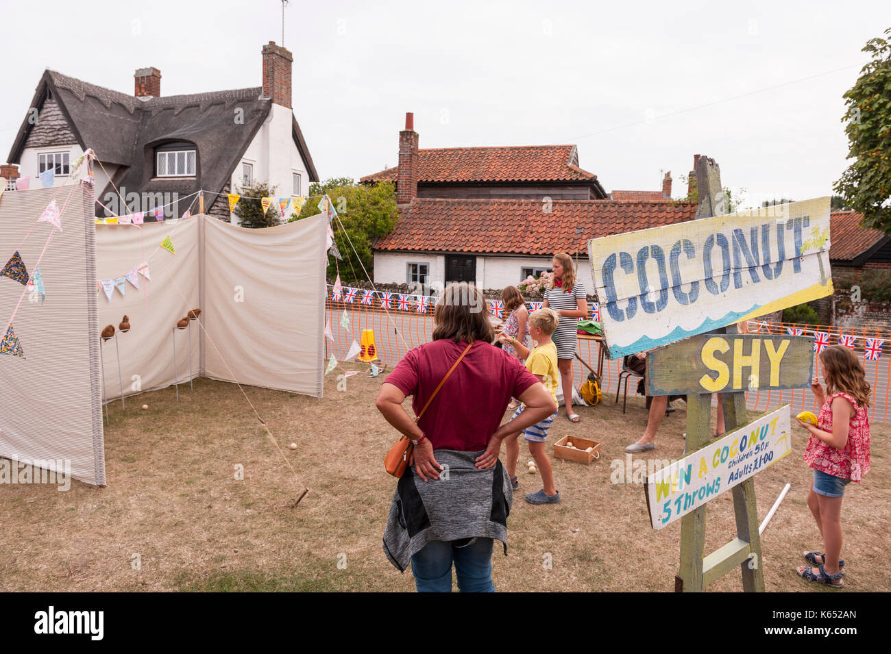 The Coconut shy at the village fete in Walberswick , Suffolk , England ...