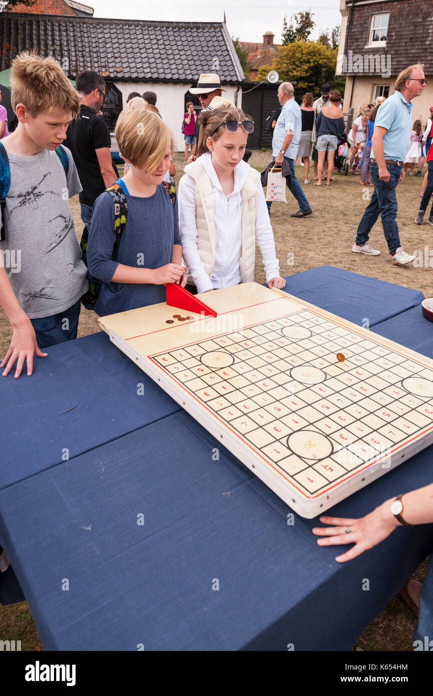 A stall at the village fete in Walberswick , Suffolk , England ...