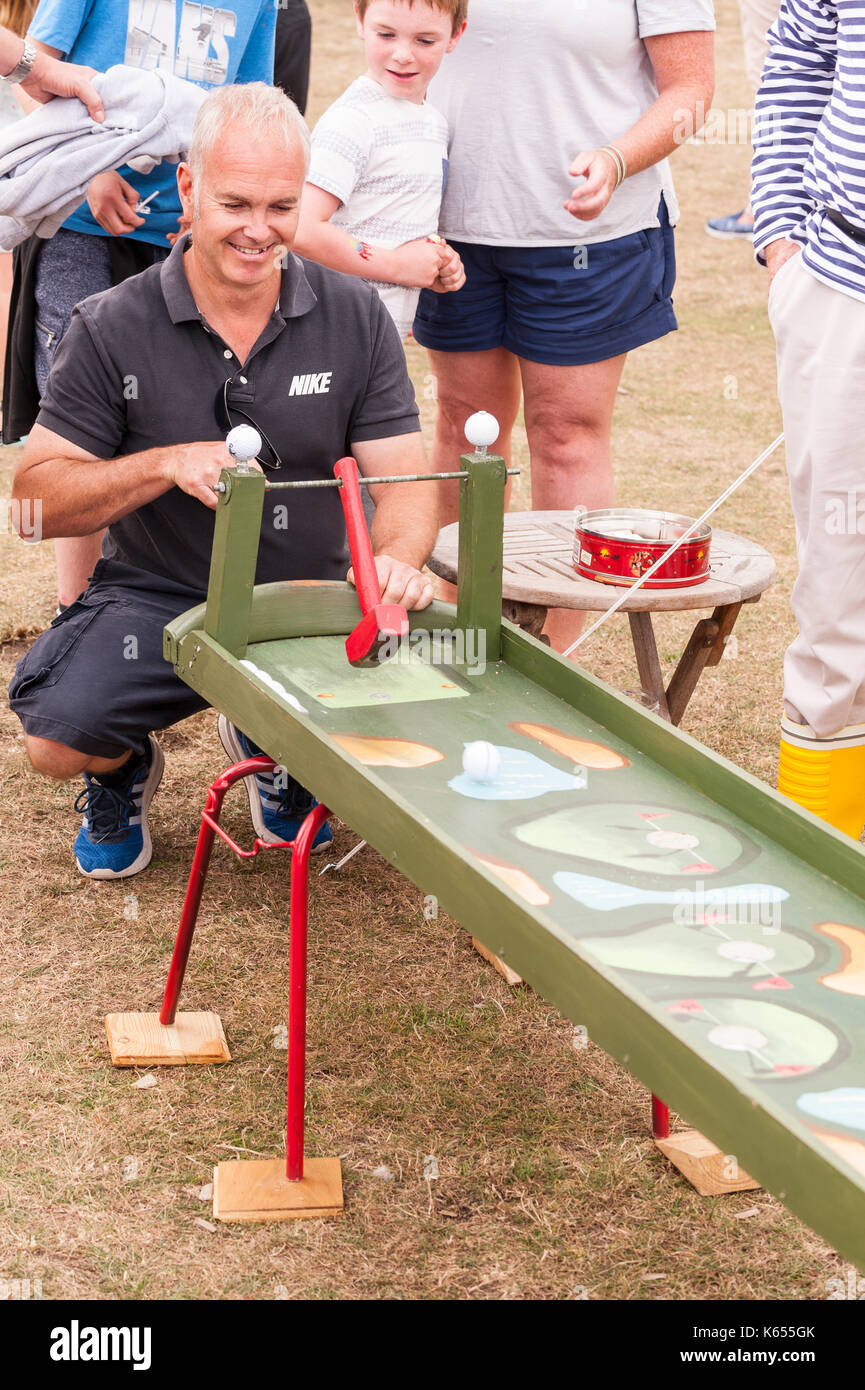 A stall at the village fete in Walberswick , Suffolk , England ...