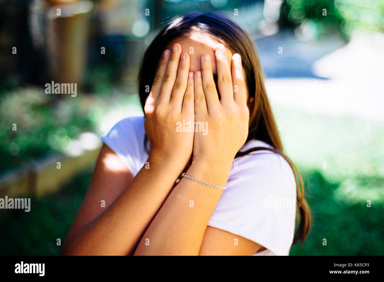 Little girl with hands on her face Stock Photo - Alamy