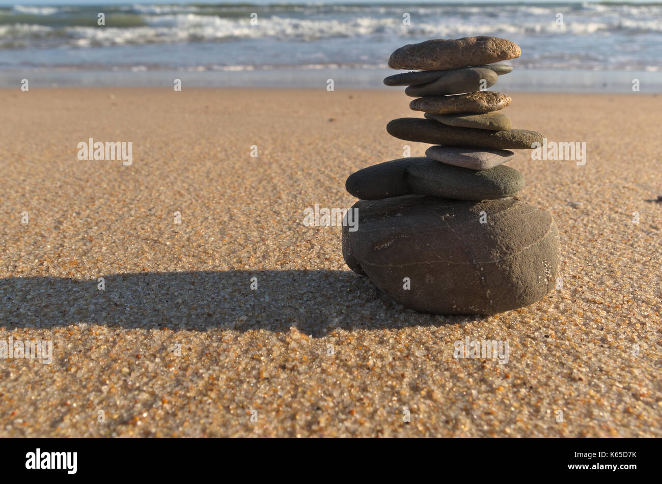 Pebbles stacked on the beach during sunset. Zen Concept Stock Photo - Alamy