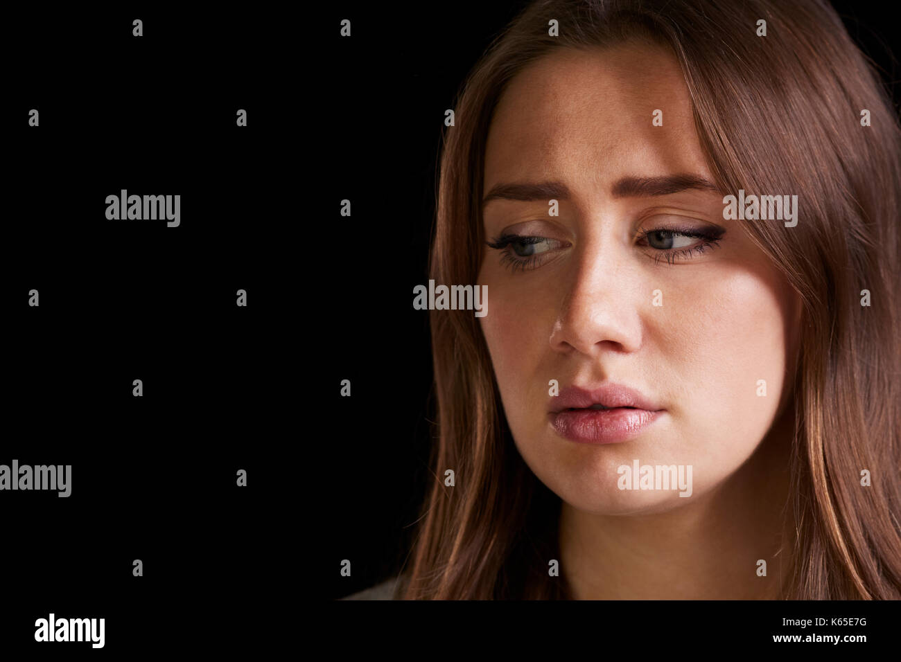 Head And Shoulders Studio Portrait Of Anxious Young Woman Stock Photo ...