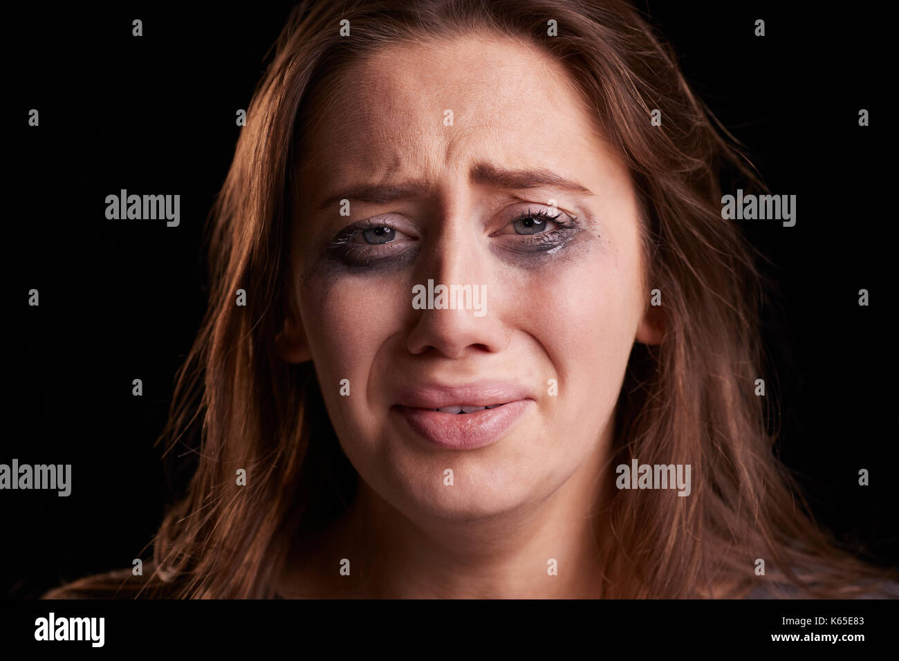 Studio Shot Of Crying Young Woman With Smudged Eye Make Up Stock Photo ...