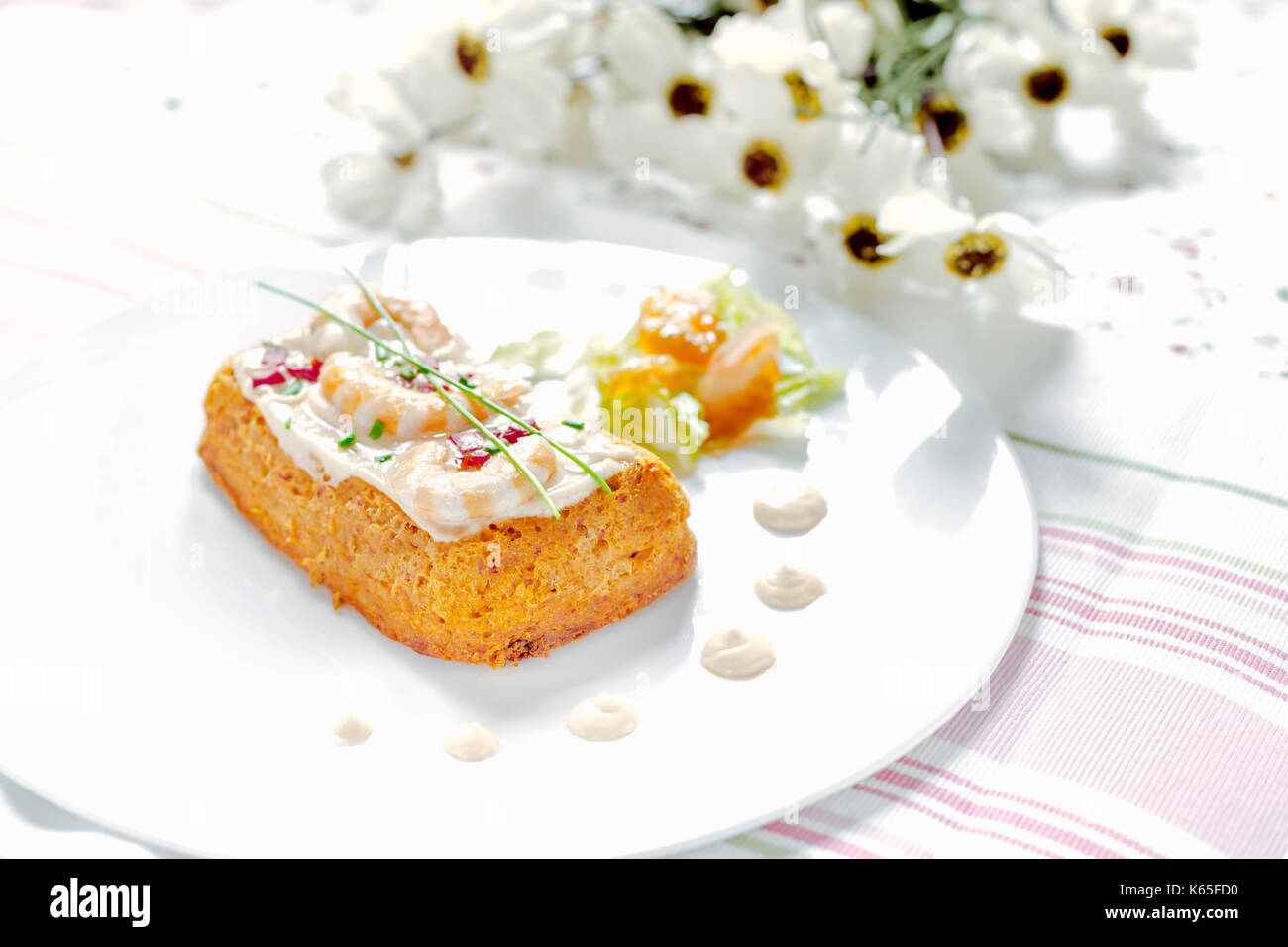 Traditional Spanish fish cake. Hake cake with tomato, shrimps and salad ...