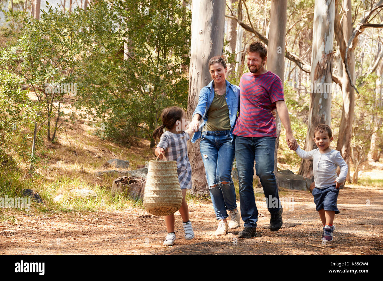 Family Walking Along Path Through Forest Together Stock Photo - Alamy