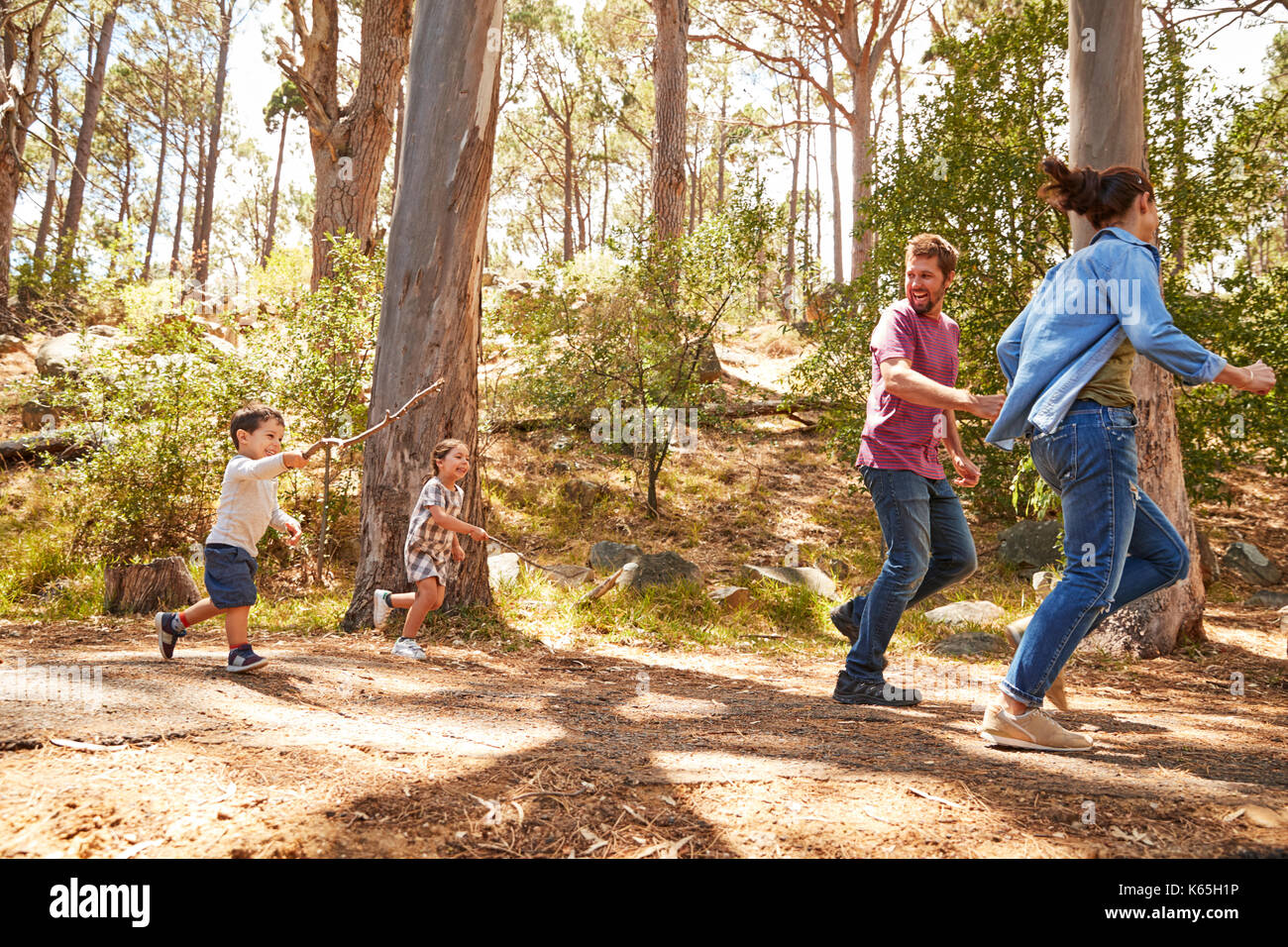 Father and daughter hiking through the forest hi-res stock photography ...