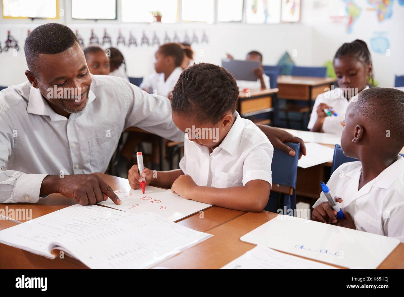 Students helping each other children hi-res stock photography and ...