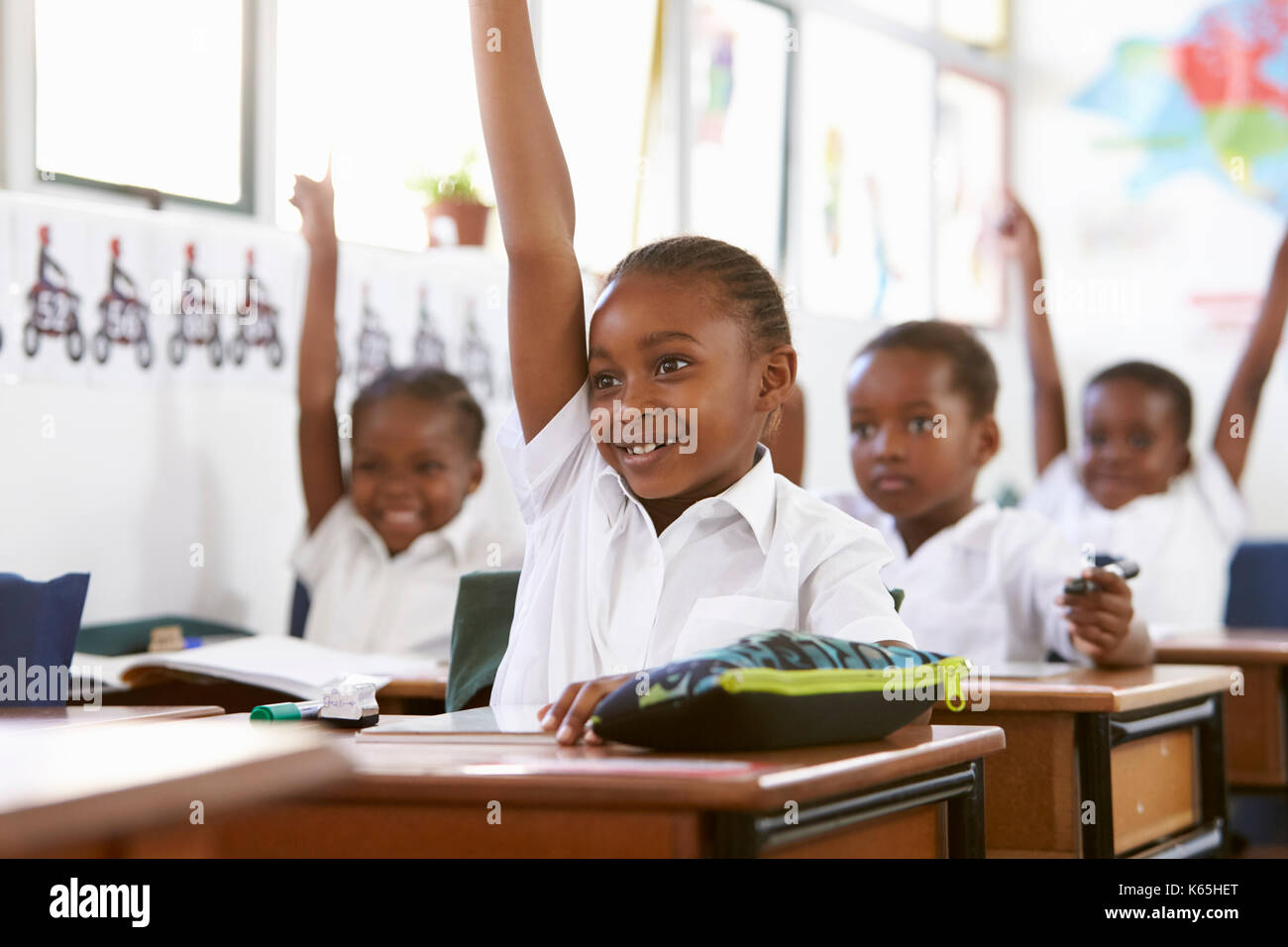 Kids raising hands classroom hi-res stock photography and images - Alamy