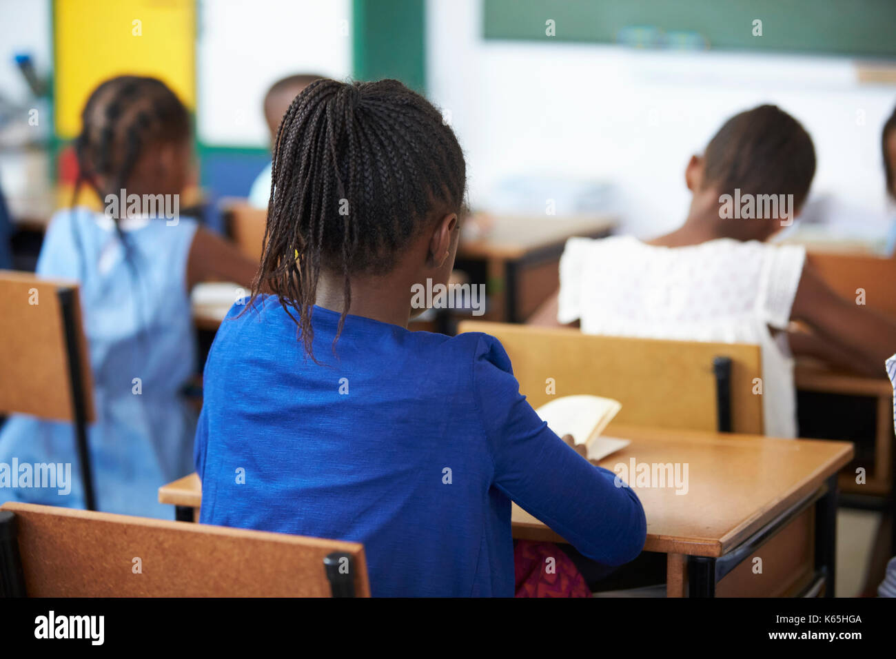 Back view of kids during a lesson at an elementary school Stock Photo ...