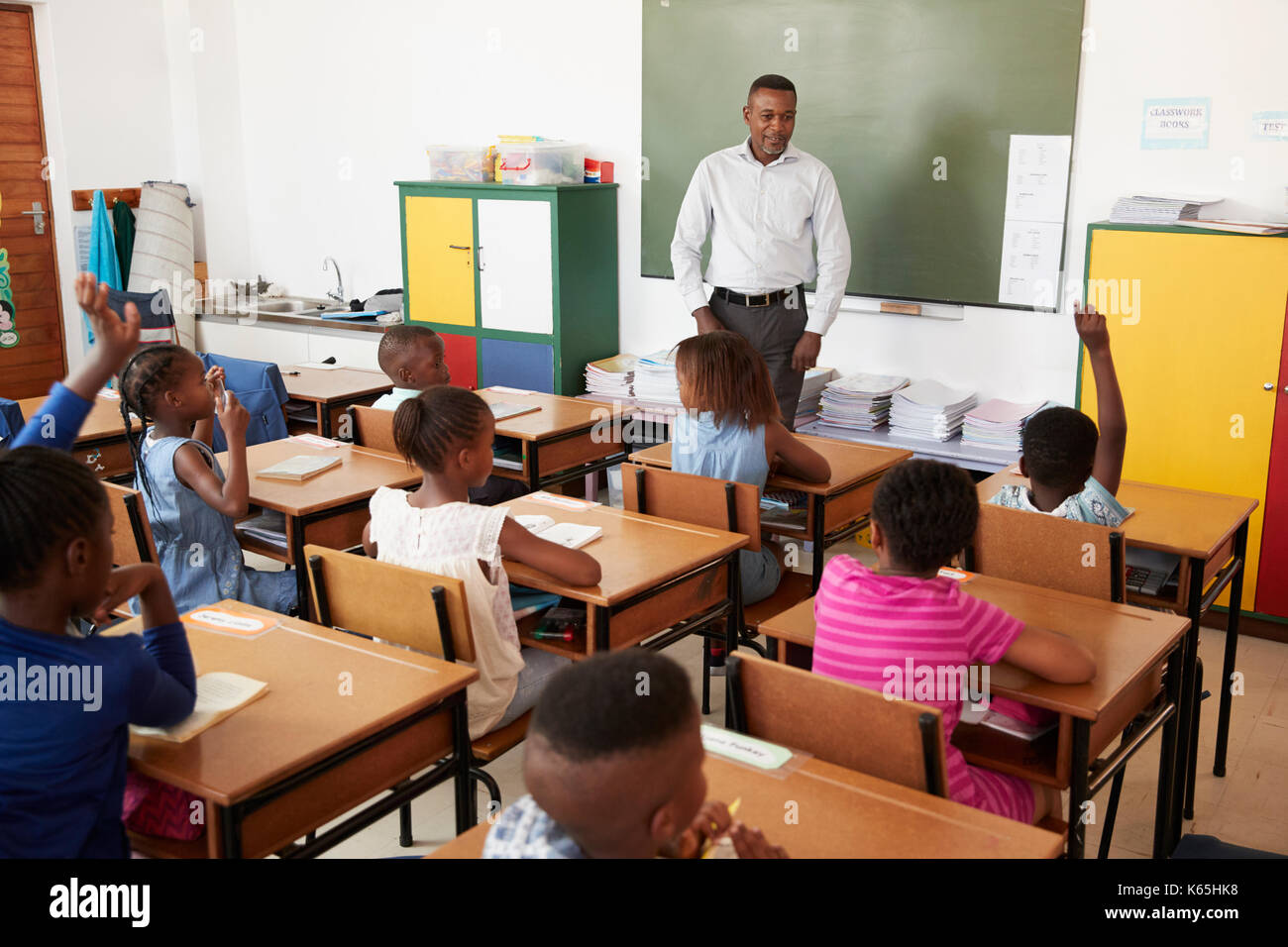 Teacher and kids during a lesson at an elementary school Stock Photo ...