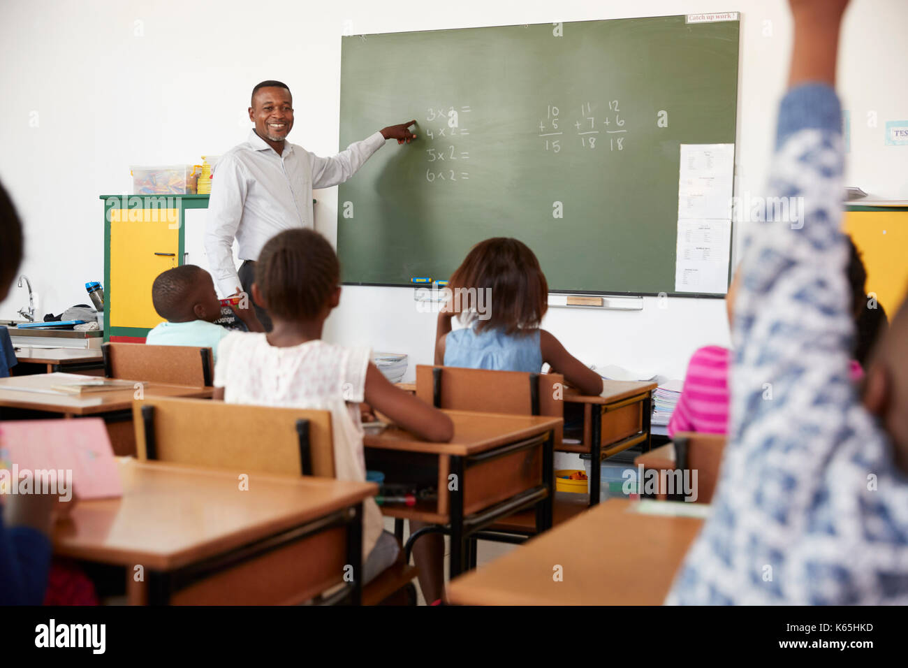 Teacher using chalkboard in a lesson at an elementary school Stock ...