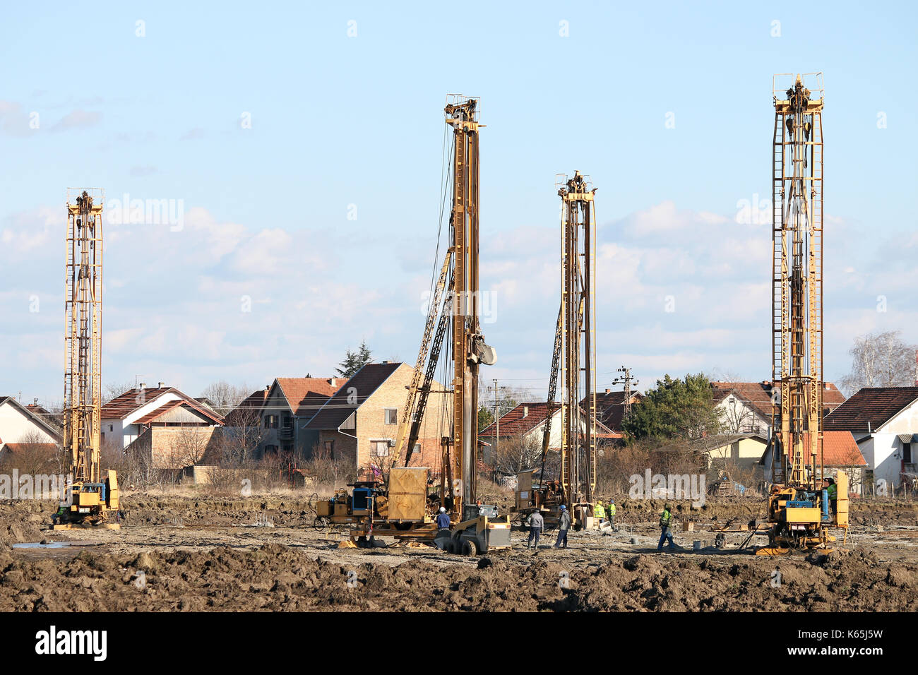 workers and four hydraulic drilling machines on construction site Stock ...