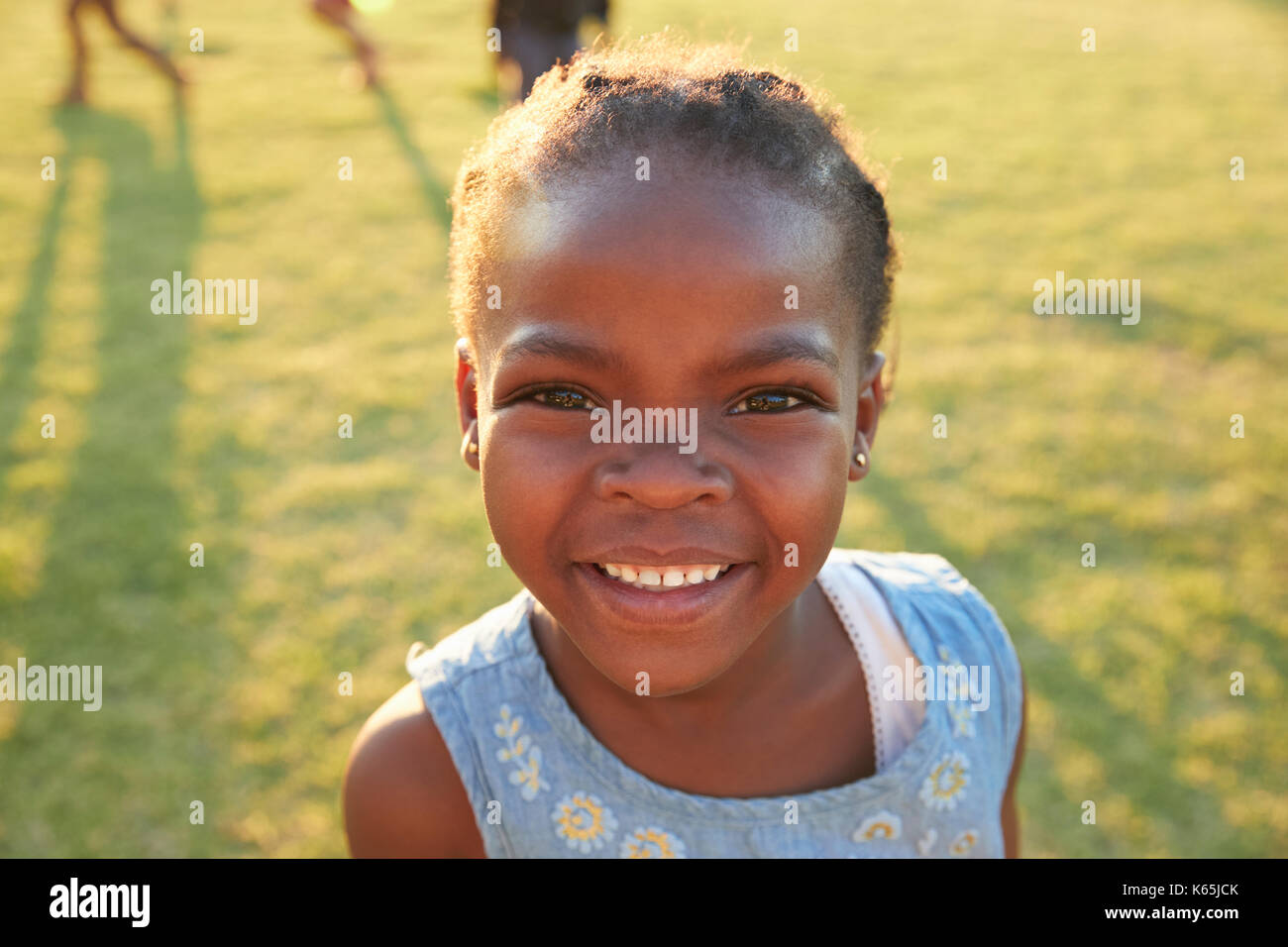 African elementary school girl smiling to camera outdoors Stock Photo ...