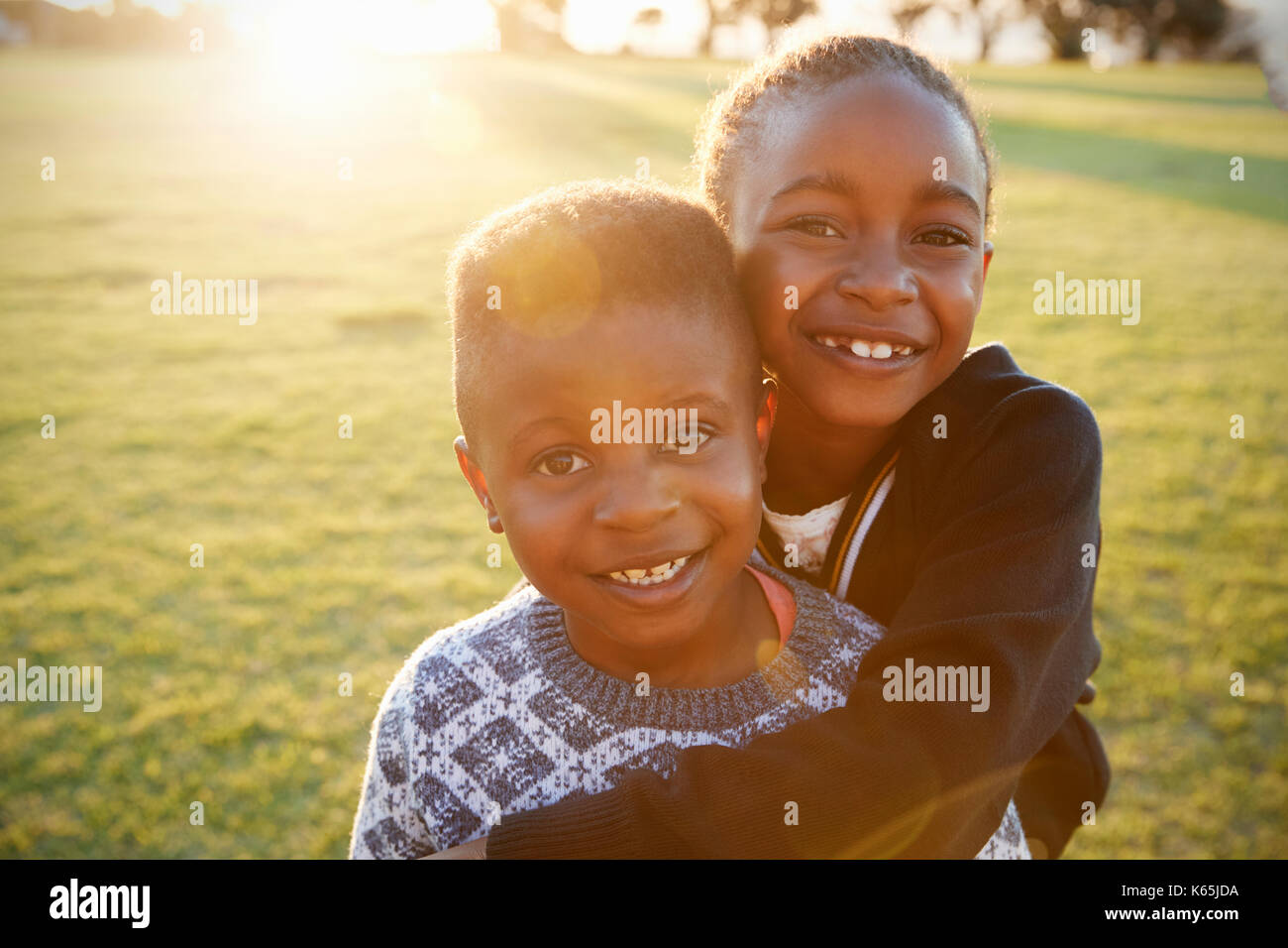 African elementary school boy and girl hugging outdoors Stock Photo - Alamy