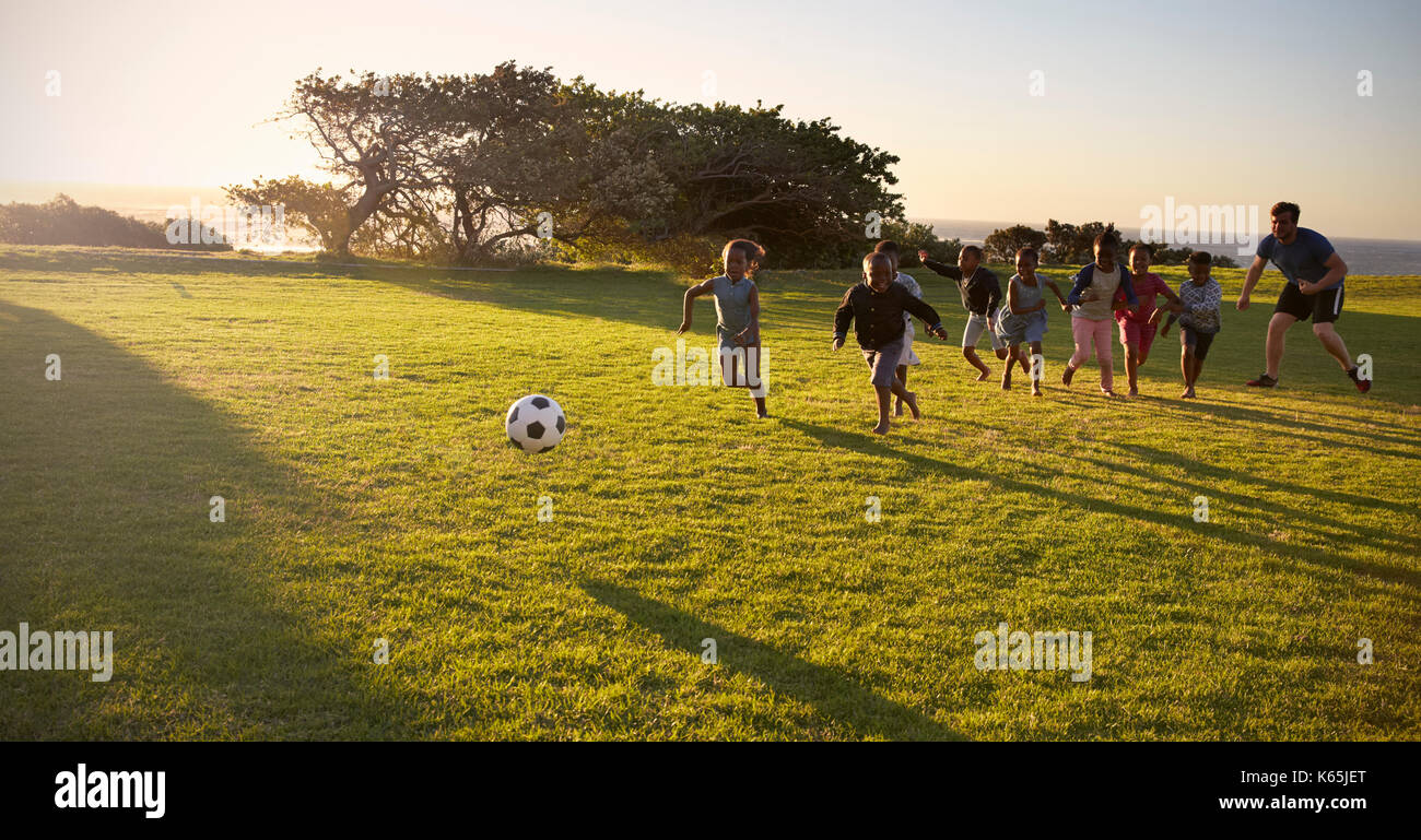 Kids Playing Football In Field High Resolution Stock Photography and ...