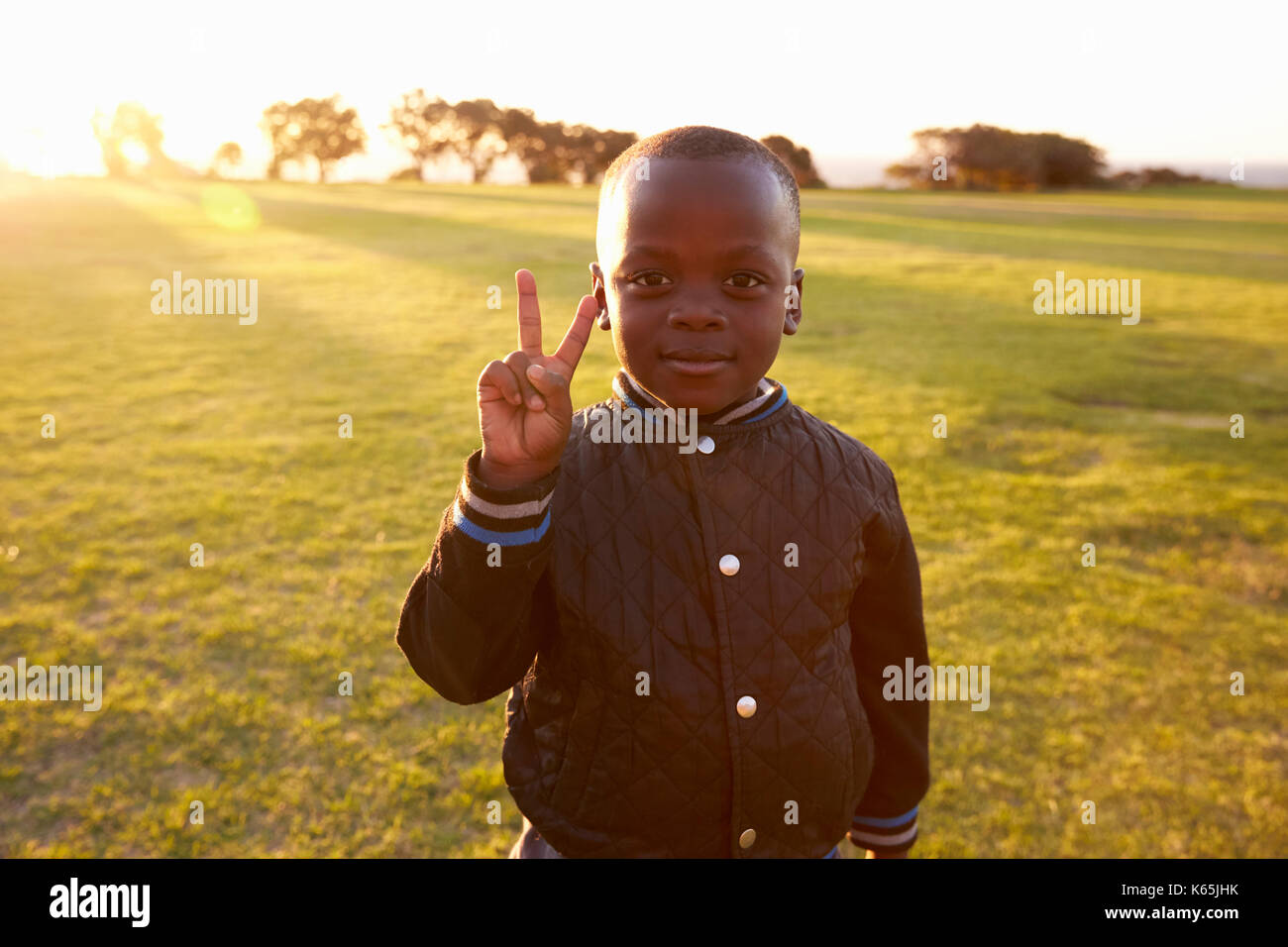 African elementary school boy making peace sign Stock Photo - Alamy