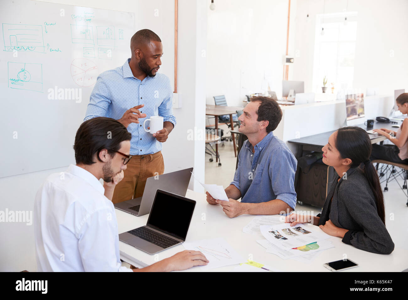 Young black man presenting an office meeting at a whiteboard Stock ...