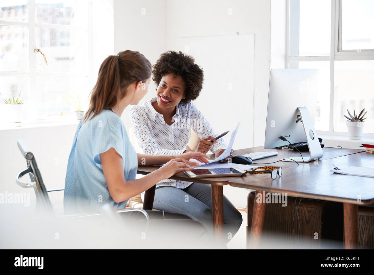 Close up two colleagues working together desk office hi-res stock ...