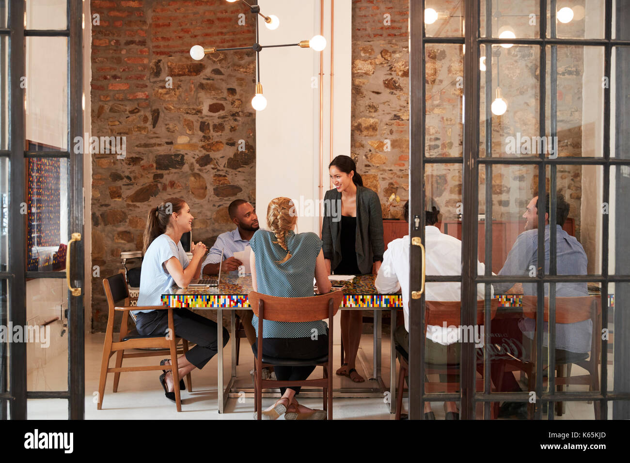 Female boss addressing business team in a meeting room Stock Photo - Alamy
