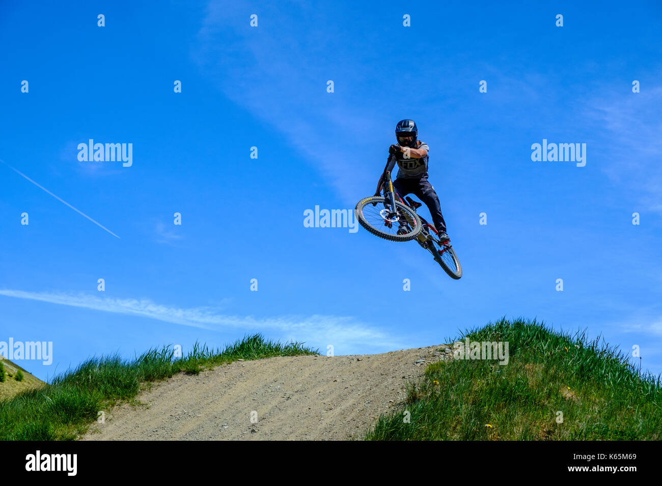 Downhill cyclist in action jumping in the Motolino Bike Park Stock ...