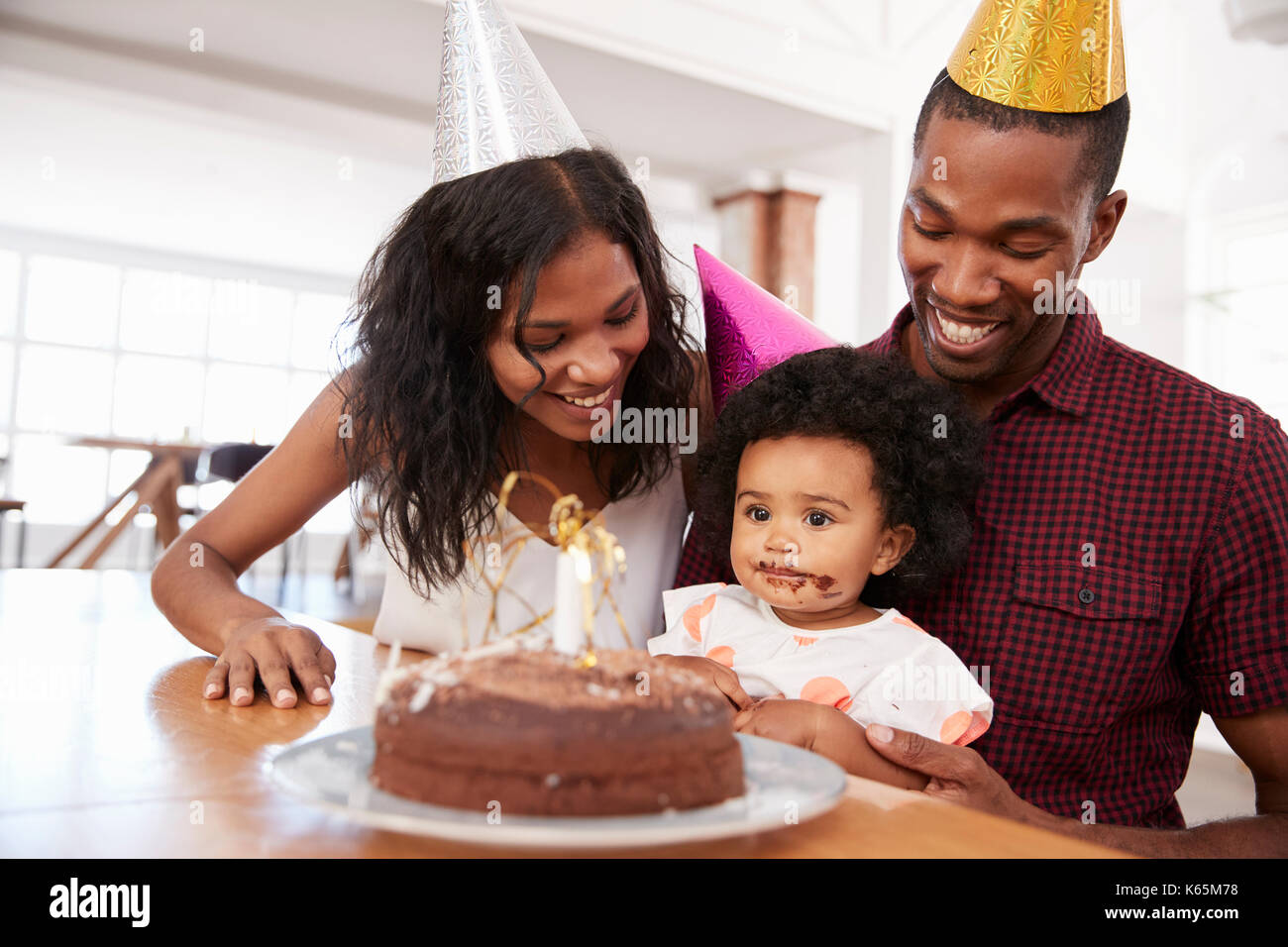 Parents Celebrating Birthday With Young Daughter At Home Stock Photo ...