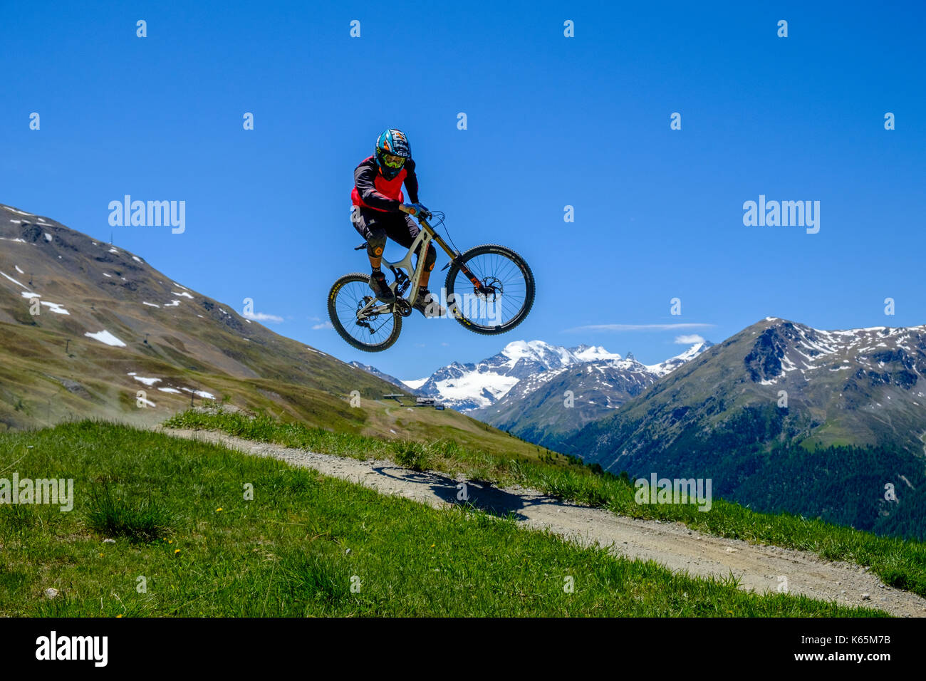 Downhill cyclist in action jumping in the Motolino Bike Park Stock ...