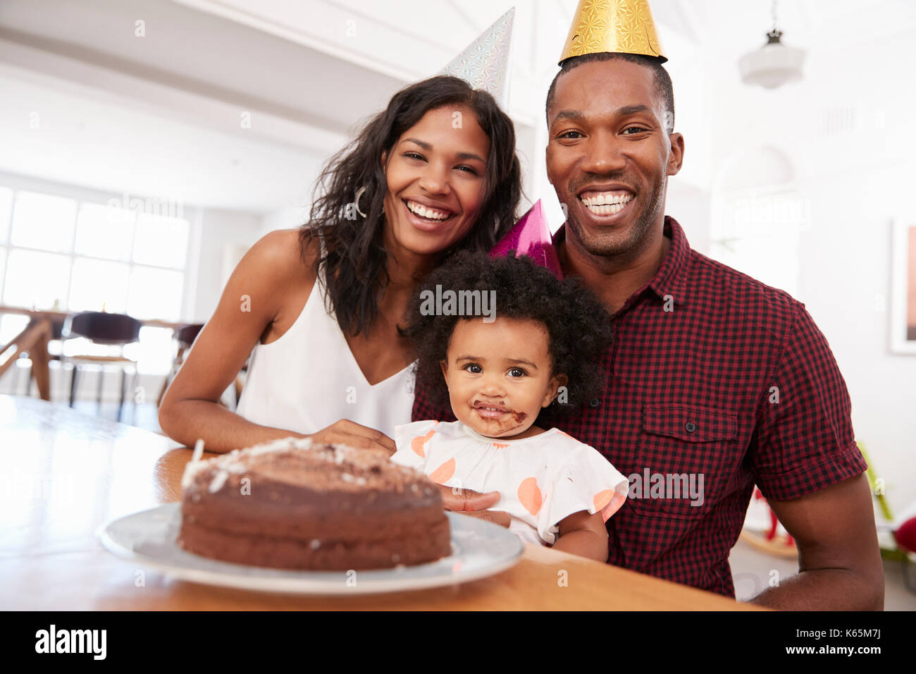 Parents Celebrating Birthday With Young Daughter At Home Stock Photo ...