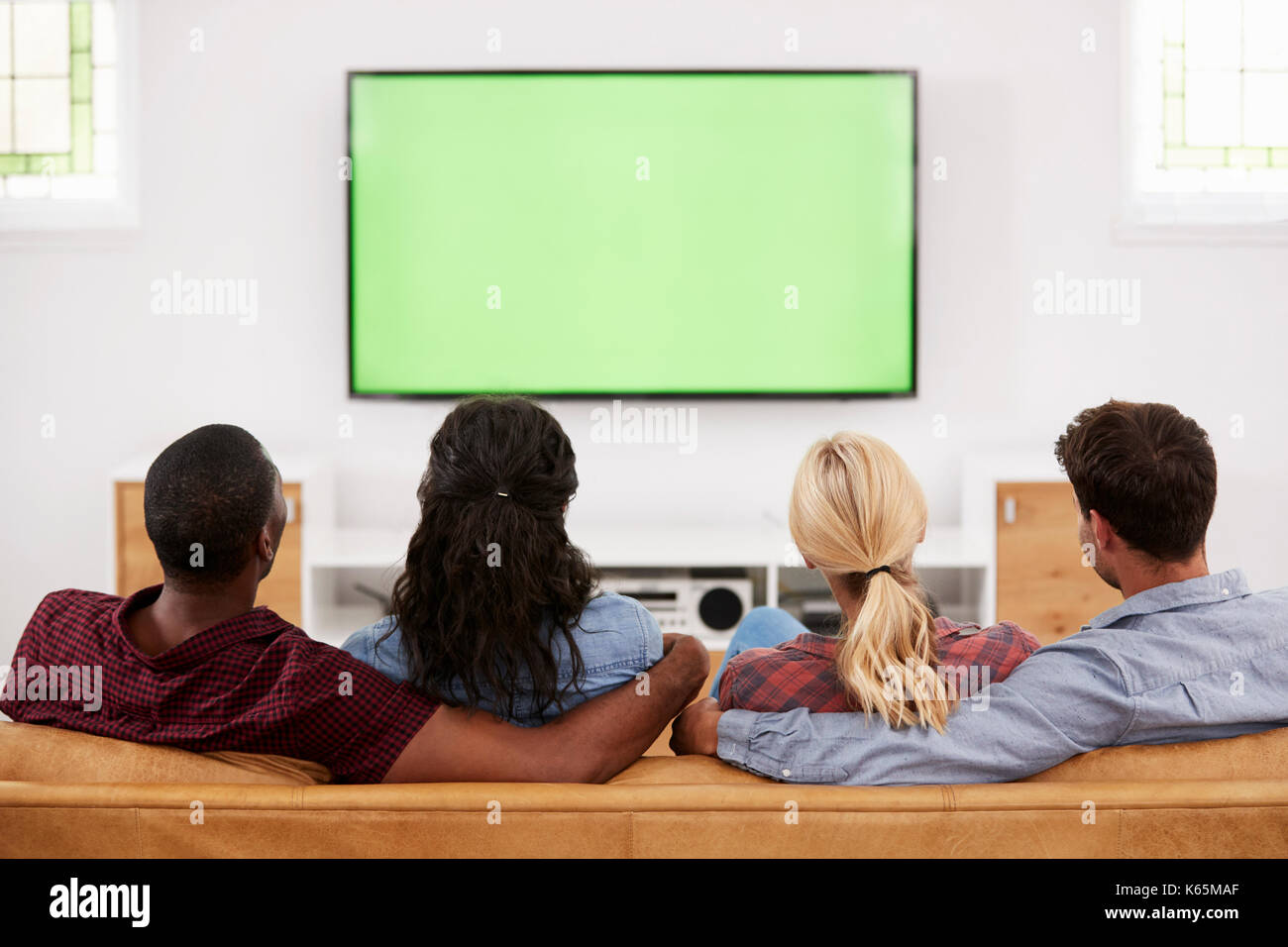 Rear View Of Group Of Young Friends Watching Television Together Stock ...