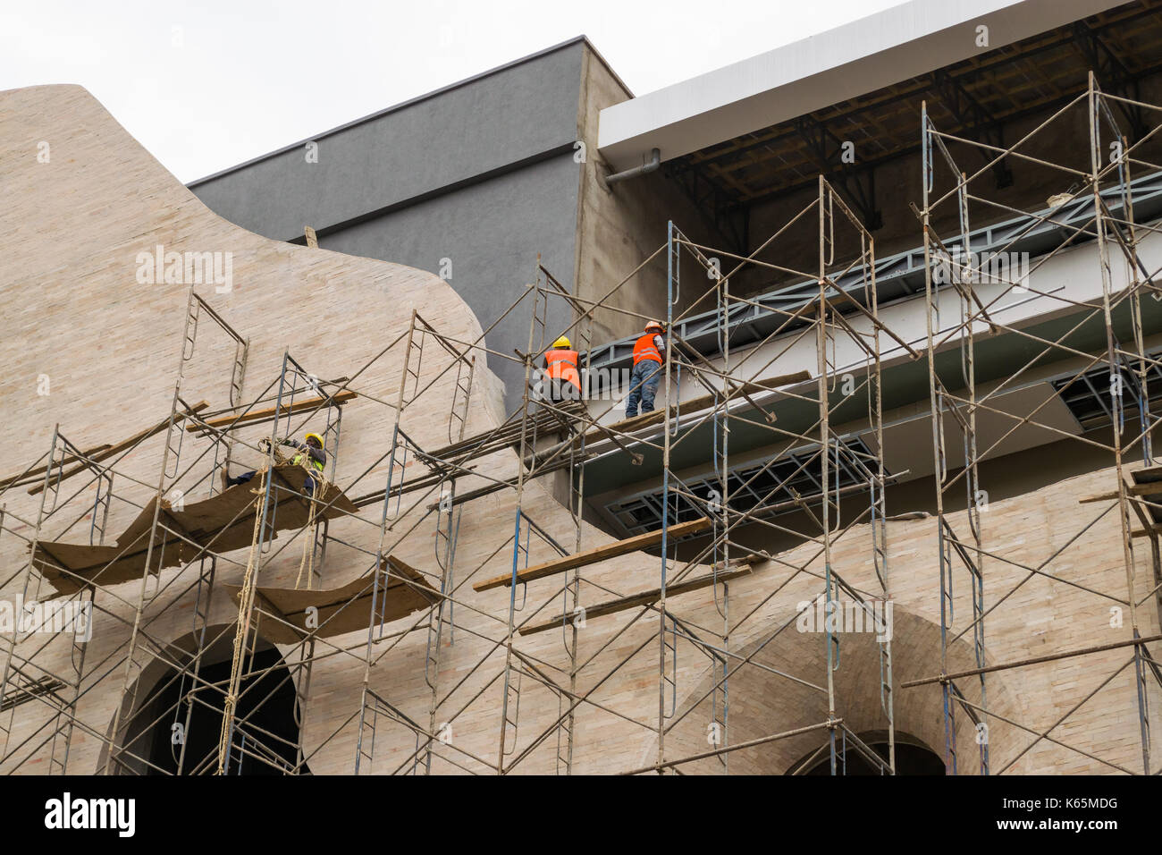 Workers on scaffolding of Village Market extension building under ...