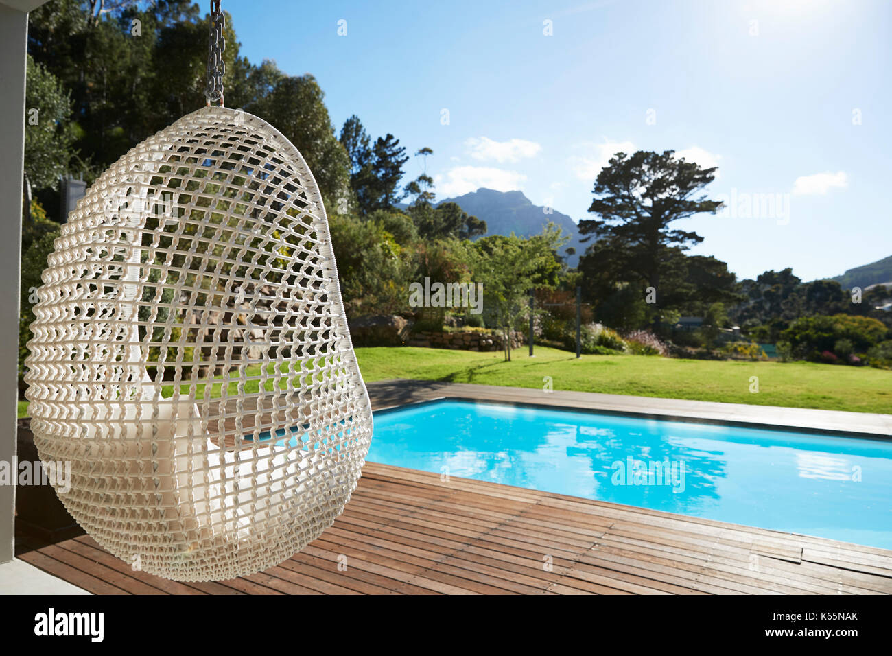 Suspended Seat Next To Decking Around Outdoor Swimming Pool Stock Photo ...