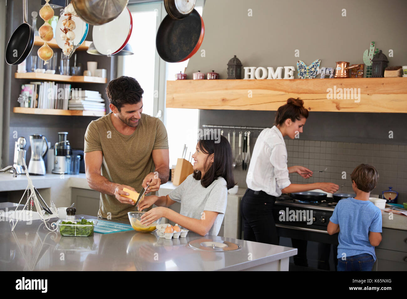 Family In Kitchen Making Morning Breakfast Together Stock Photo - Alamy