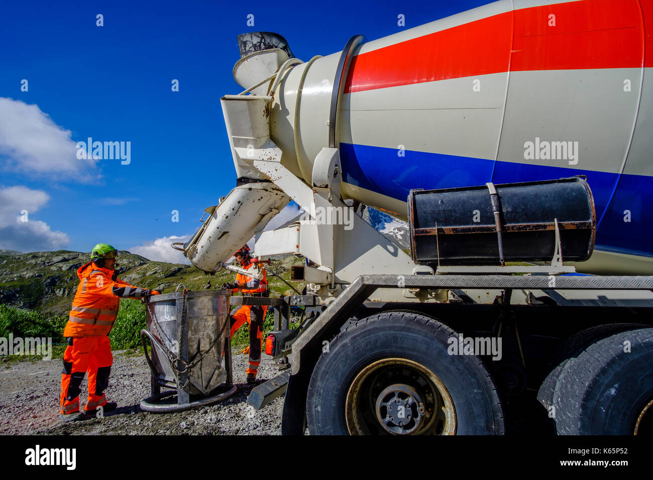 Workers of the company Swiss Helicopters are preparing the load for ...