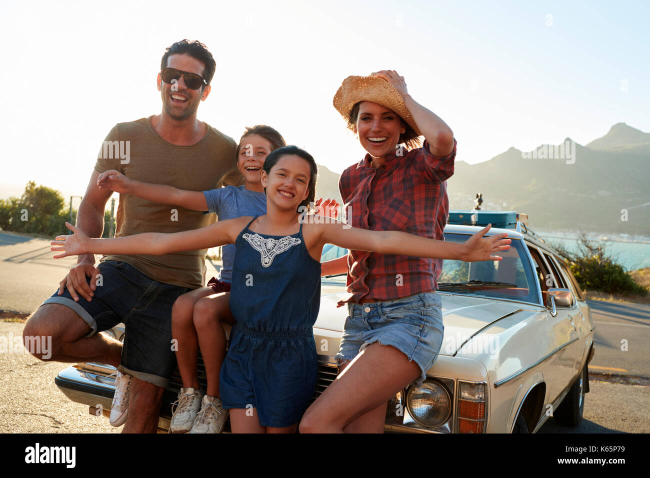 Portrait Of Family Standing Next To Classic Car Stock Photo - Alamy