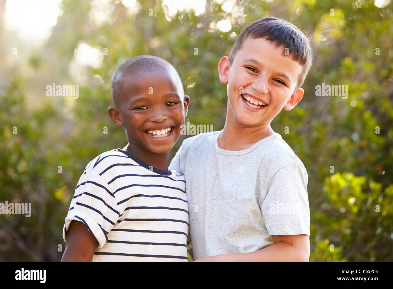 Portrait of two boys outdoors laughing and looking to camera Stock ...