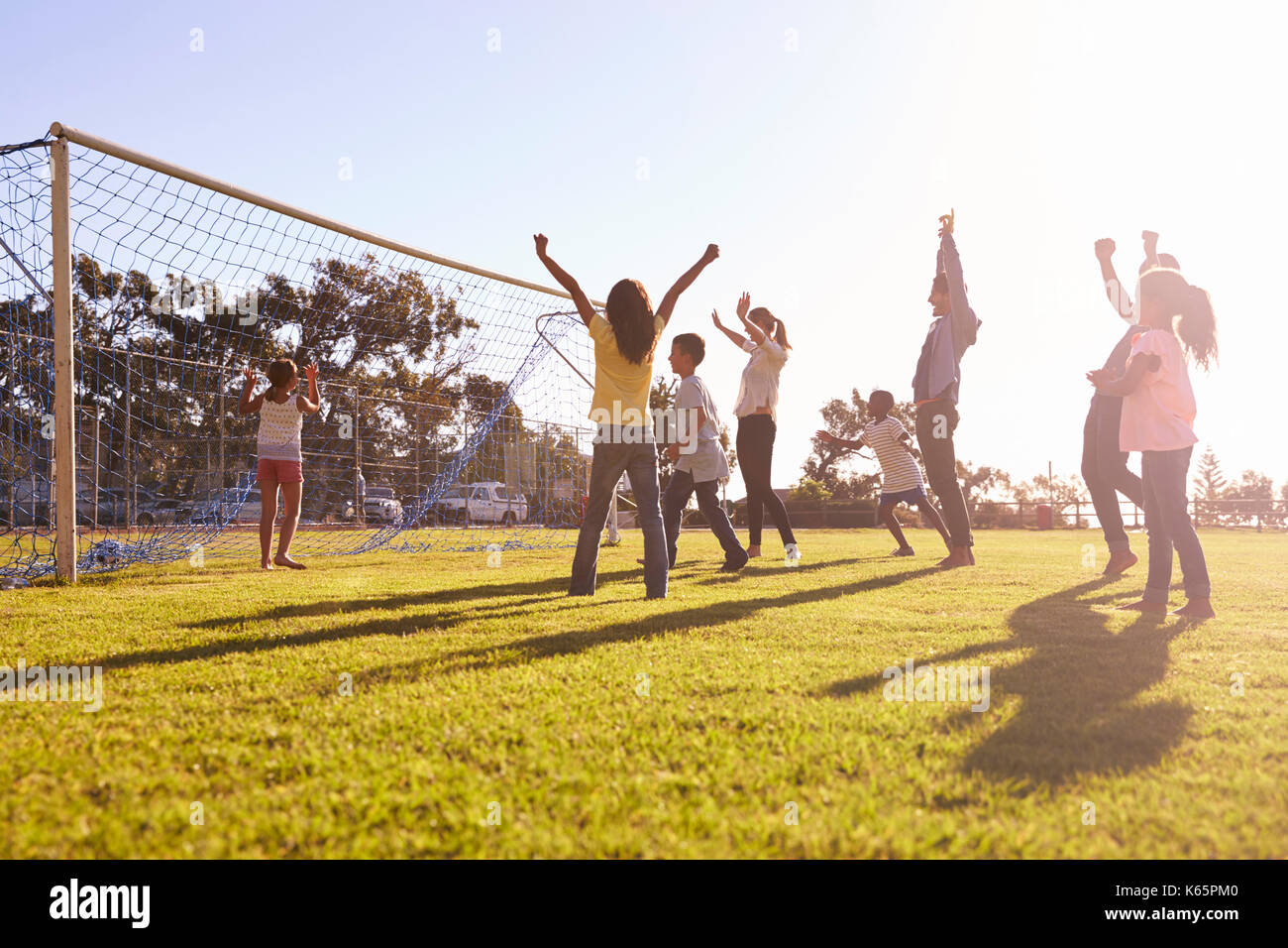 Families cheering scoring a goal during a football game Stock Photo - Alamy