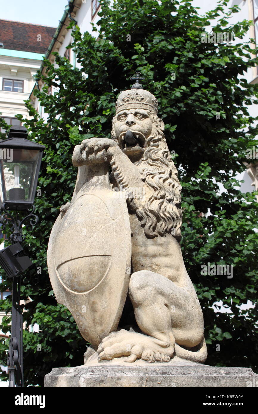 Lion statue with shield in Vienna Hofburg, Austria Stock Photo - Alamy