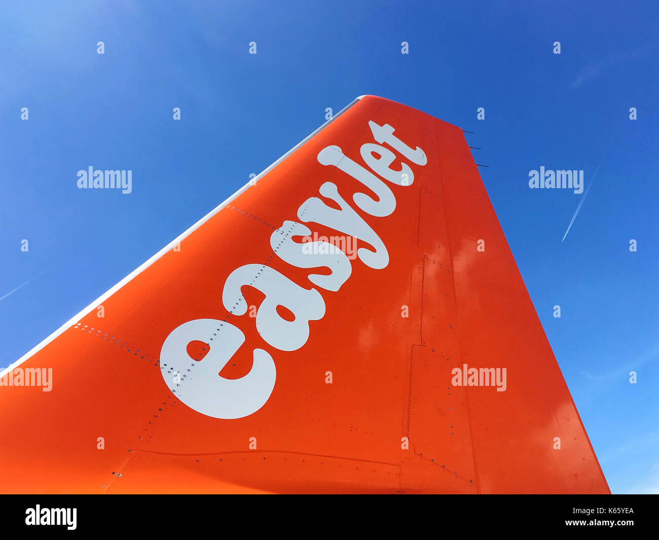 EasyJet airplane tail fin with blue sky Stock Photo - Alamy